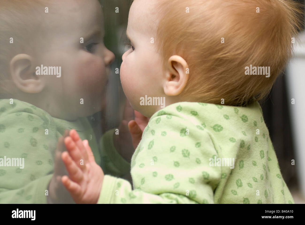 baby looking at her reflection Stock Photo - Alamy