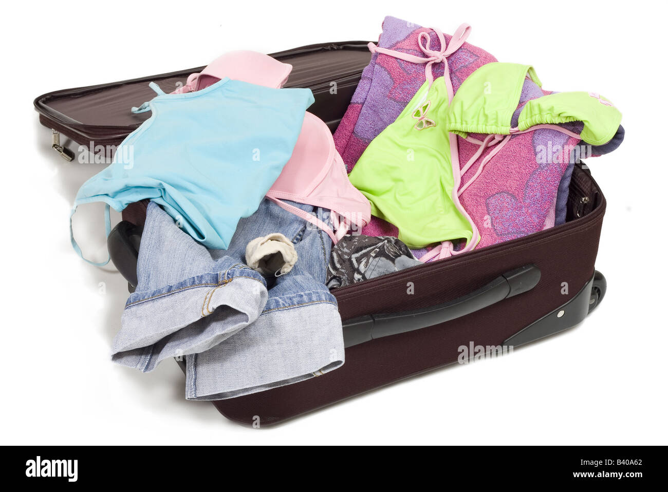 An open burgandy suitcase being packed full of clothes Stock Photo - Alamy