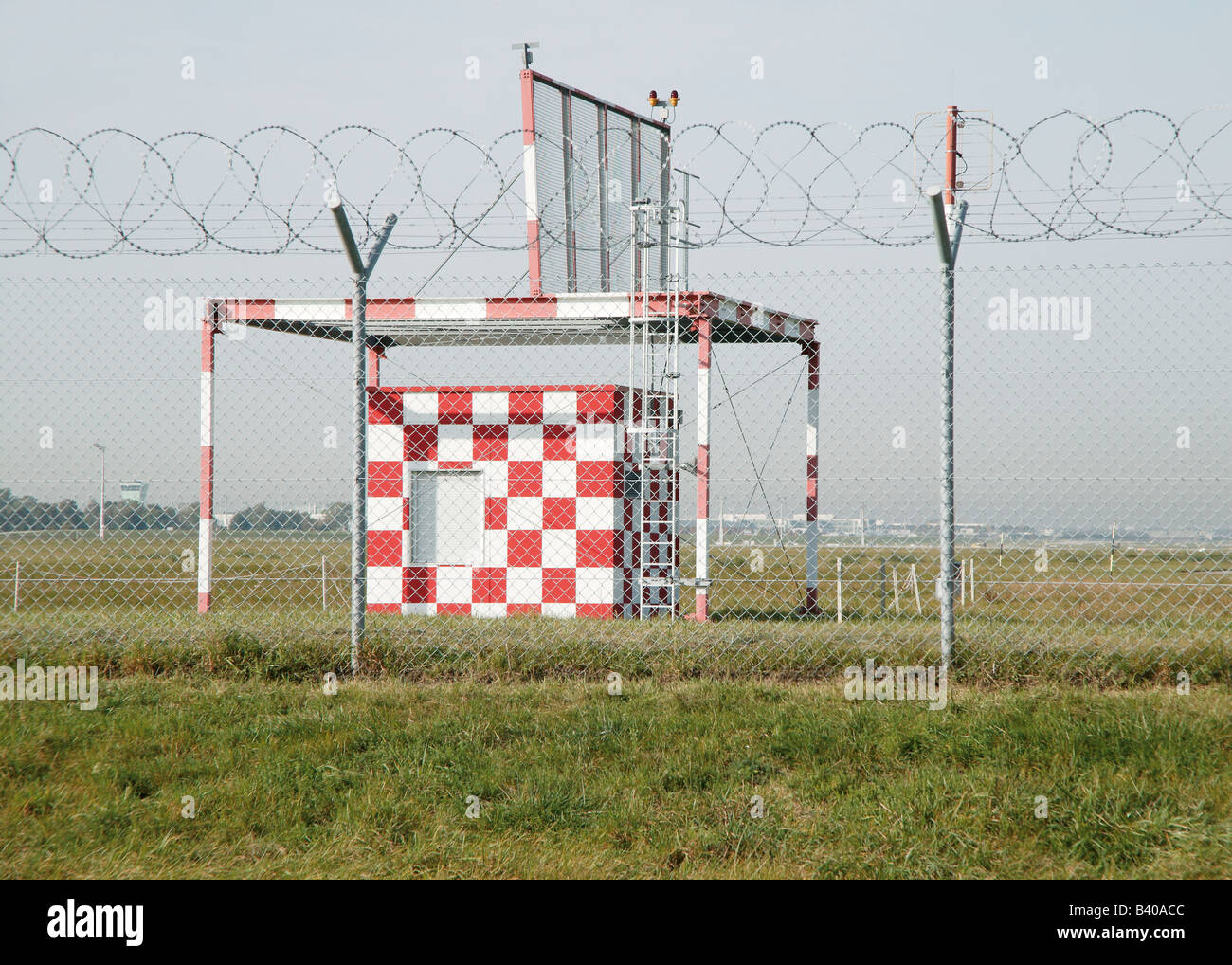 Weather station on airfield behind chain-link fence Stock Photo - Alamy