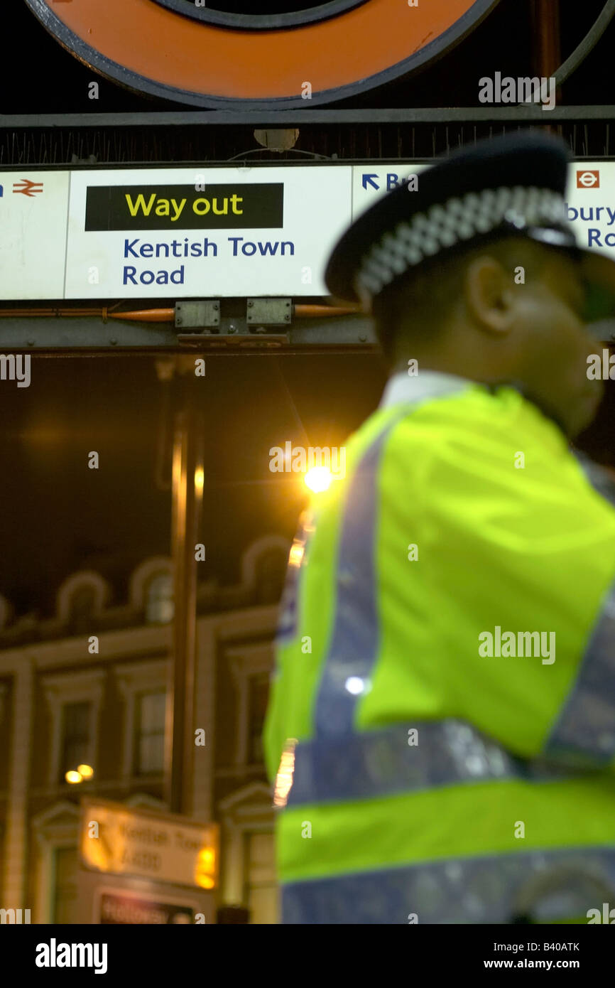 police officer in front of tube station at night Stock Photo - Alamy