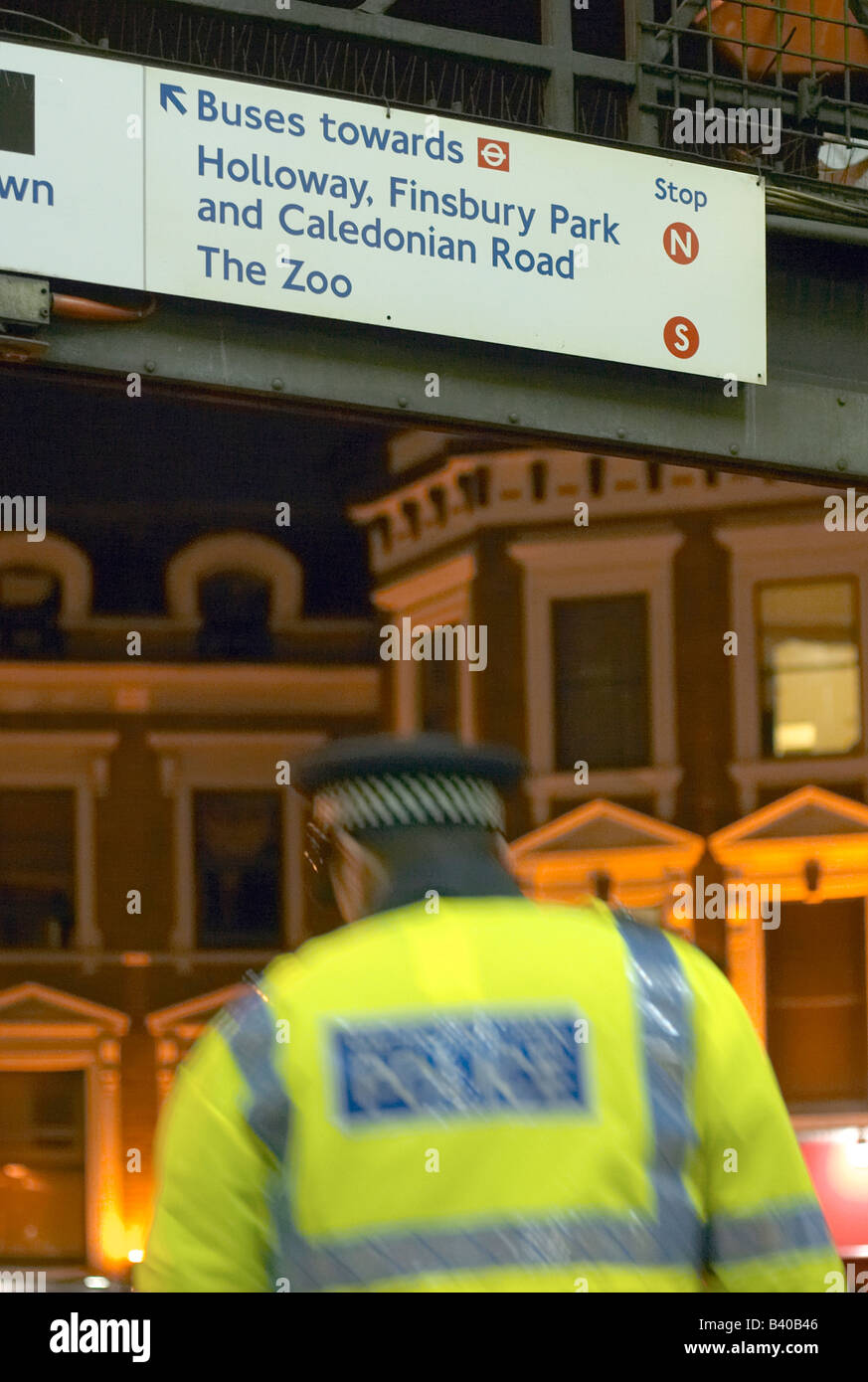 Police officer at night outside tube station Stock Photo - Alamy