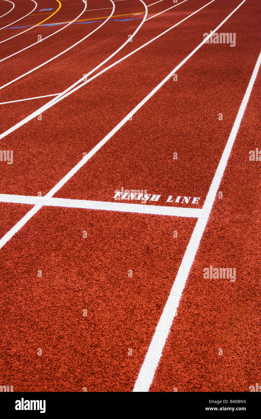 White finish line text and lane on red running track Stock Photo - Alamy