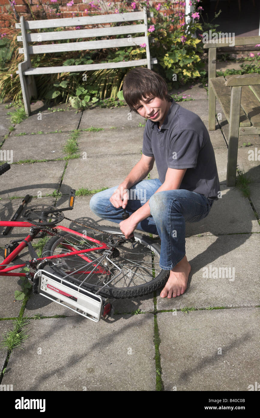 Teenager repairing his bike hi-res stock photography and images - Alamy