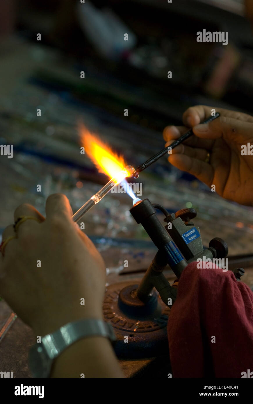 Artist shaping hot glass into a figurine Stock Photo - Alamy