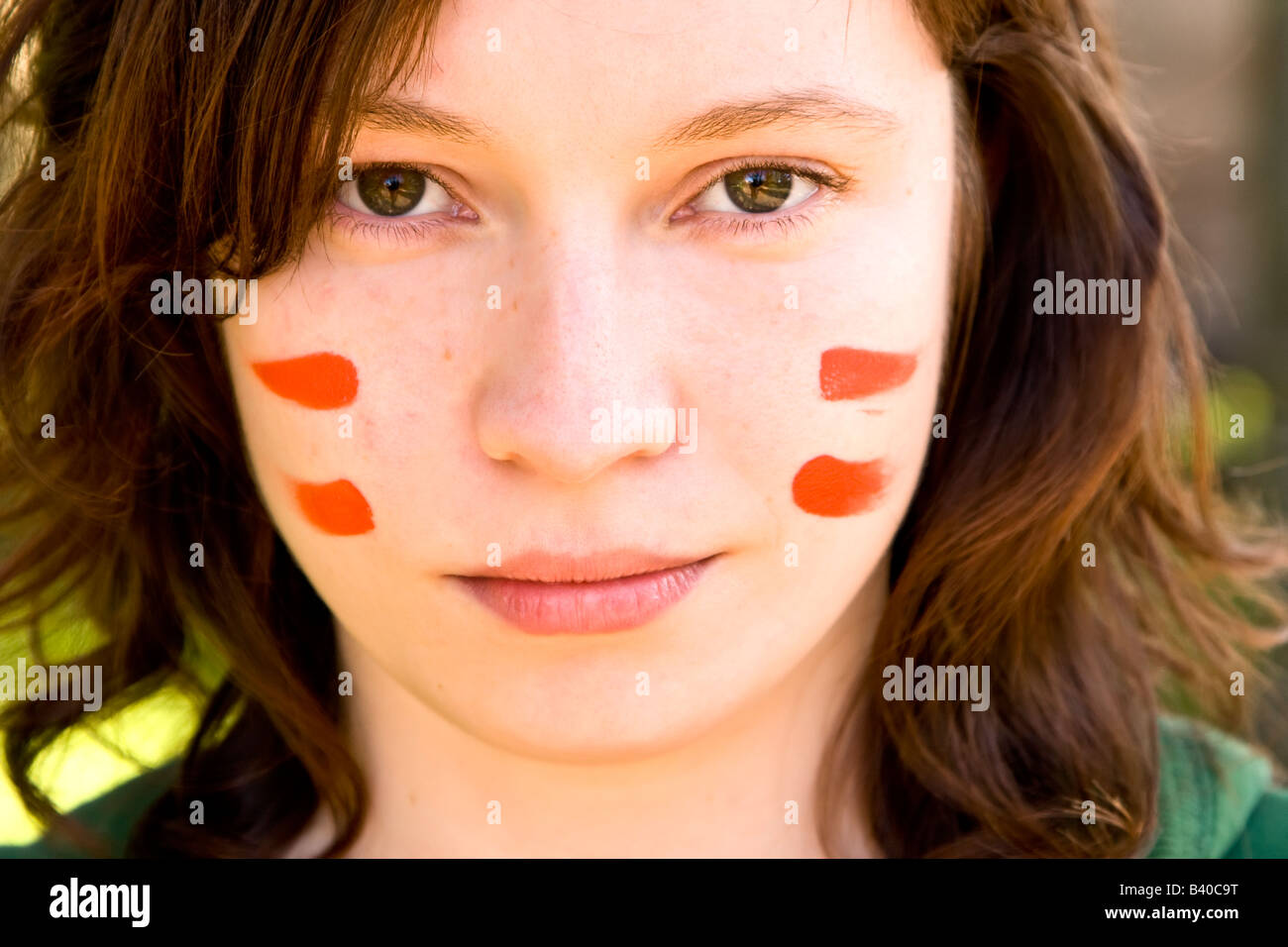 Sport fan with painted face representing Austrian flag Stock Photo - Alamy