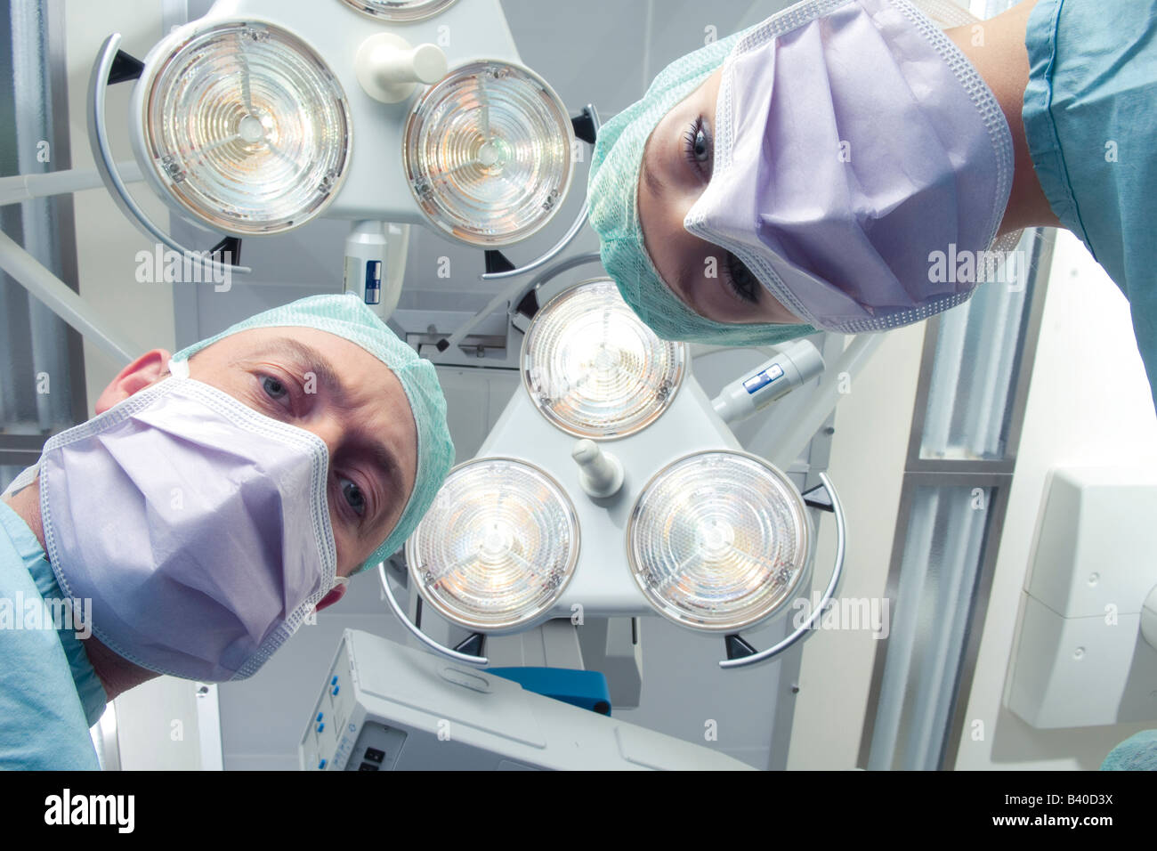 Two surgeons in an operating room looking down Stock Photo - Alamy