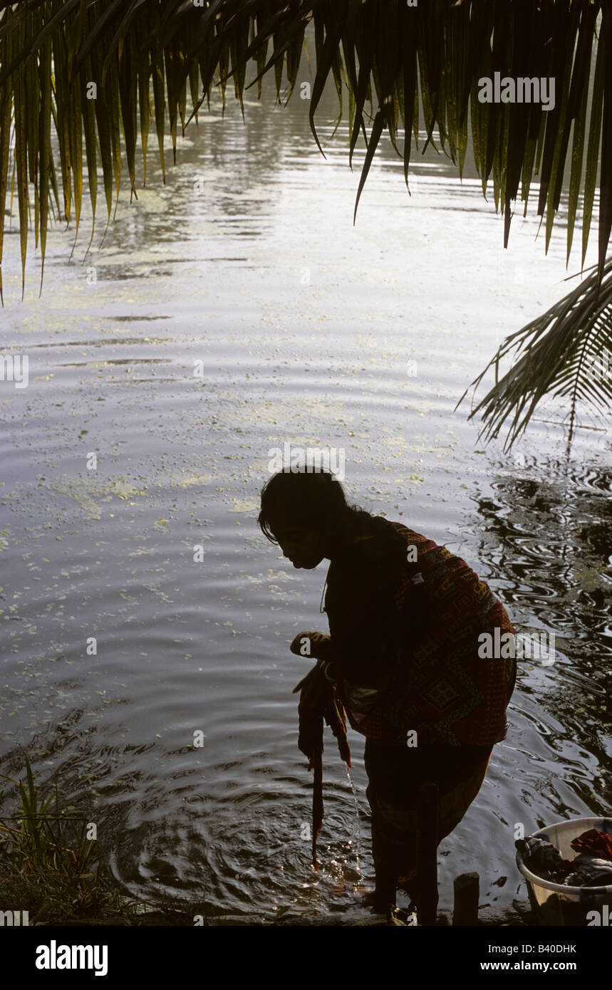 Poor rural community Young woman washing in one of many tanks or ...