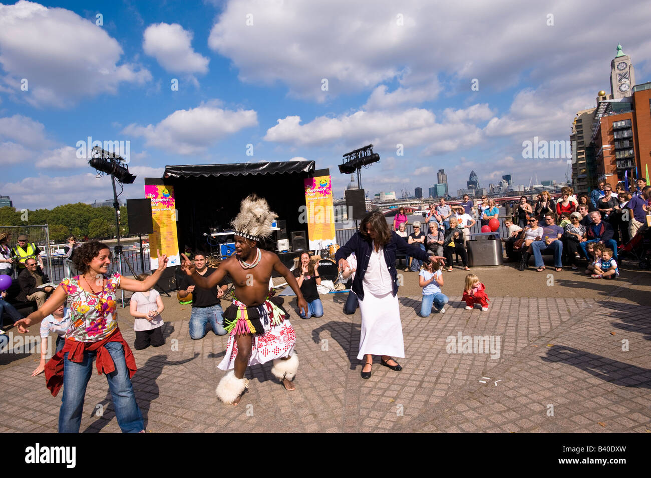 African street performer entertaining tourists and passersby during ...