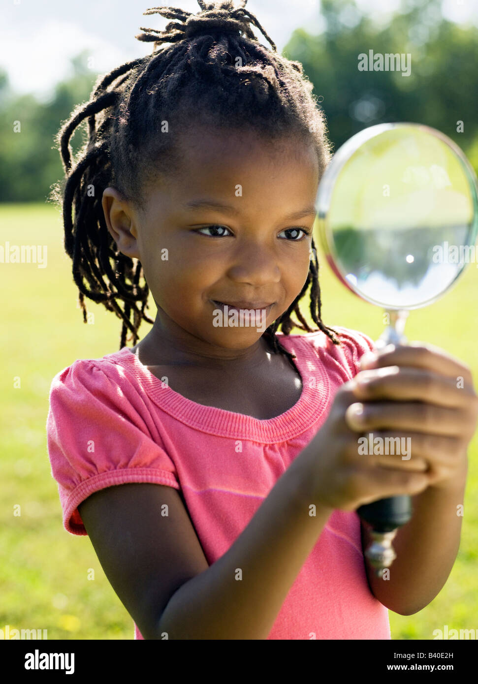 Young African American girl looking through magnifying glass Chicago ...