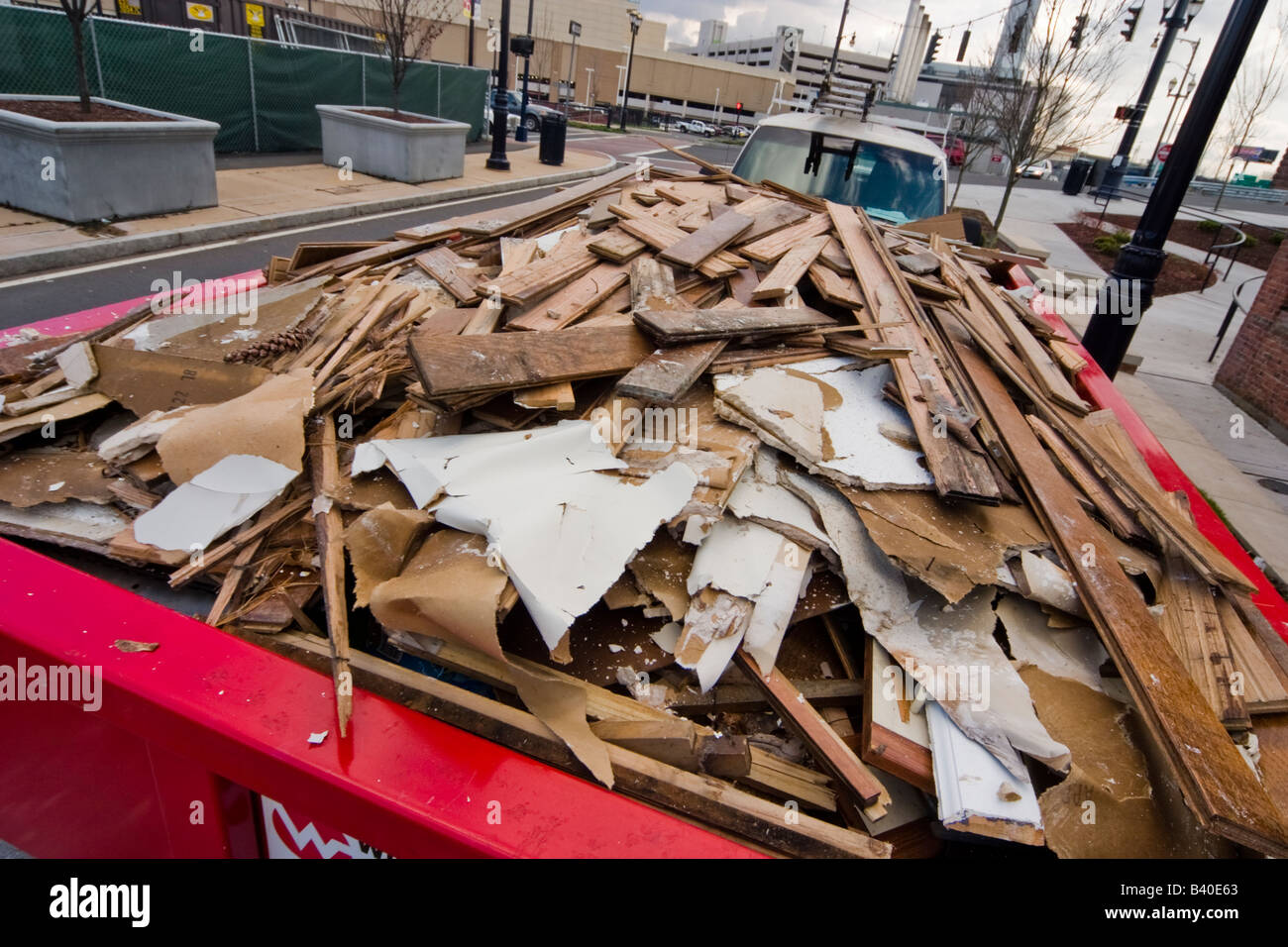 Discarded building material in a large dumpster Stock Photo - Alamy