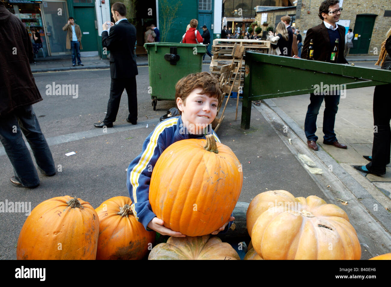 Boy buying pumpkin for Halloween, Borough Market , London Stock Photo ...