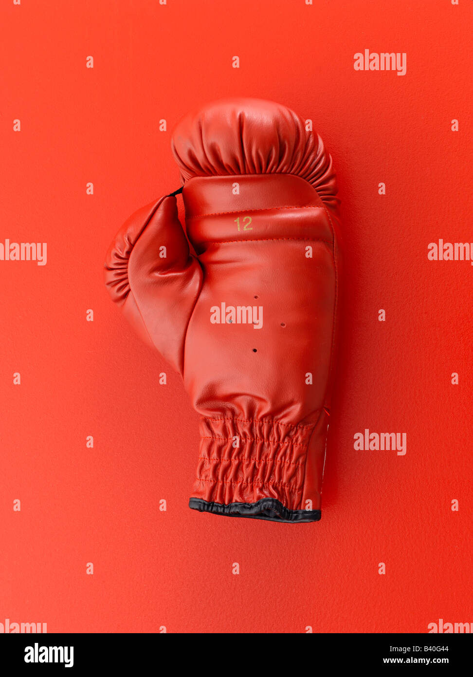 Red boxing glove on red background Stock Photo - Alamy