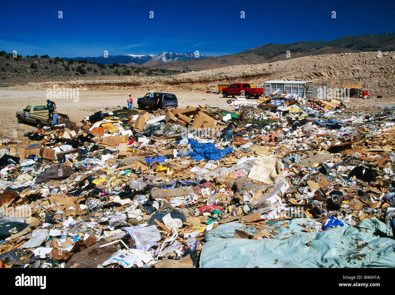 Vehicles, people dumping garbage at landfill for recycling Stock Photo ...