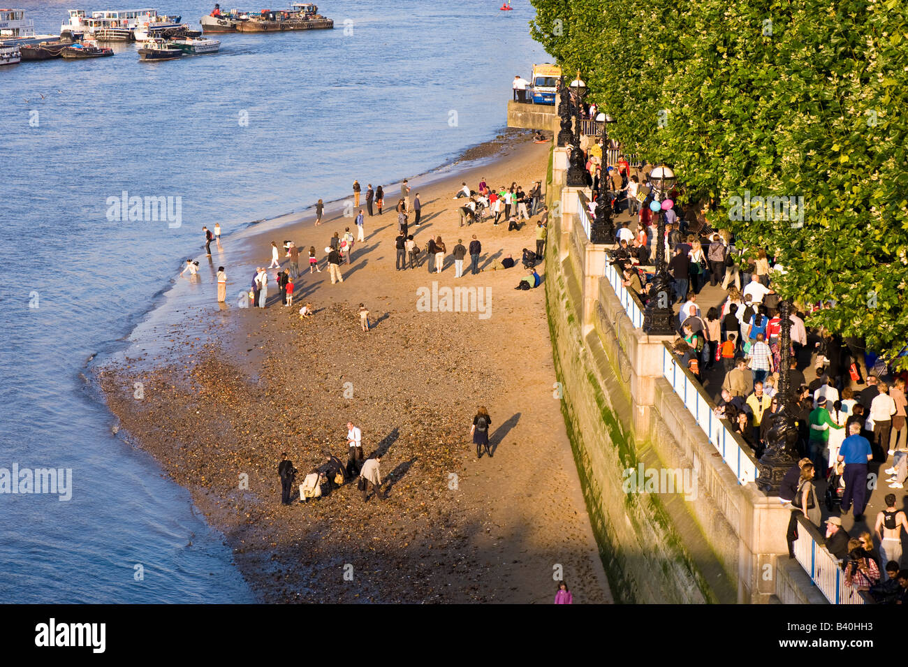 People enjoy worm summer day on beach by Thames River Southbank SE1 ...