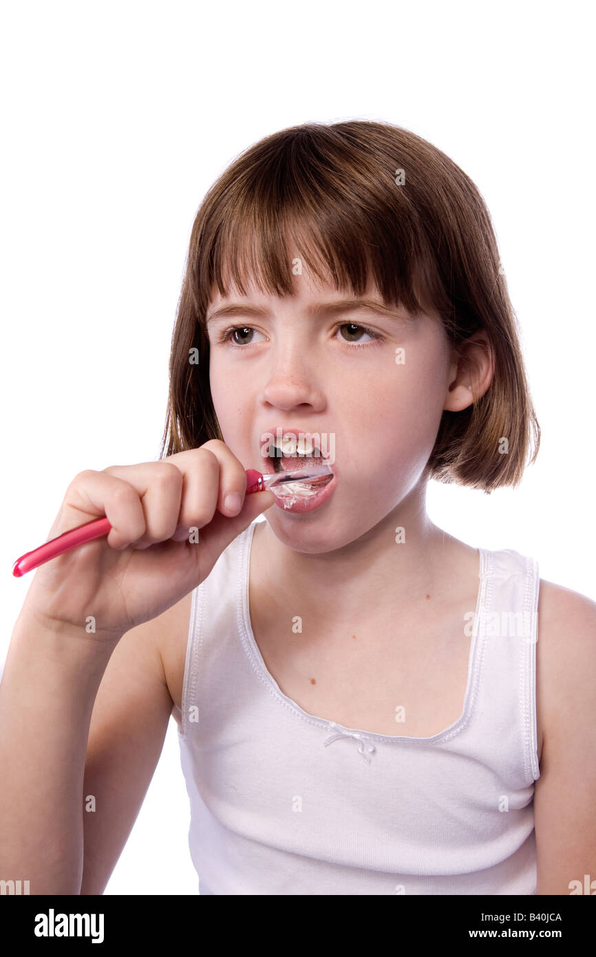 Young Brunette Girl Brushing Her Teeth Isolated On White Background