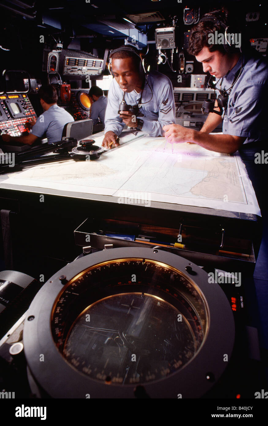 Navy seaman calculate positions in the weapons control room aboard the ...