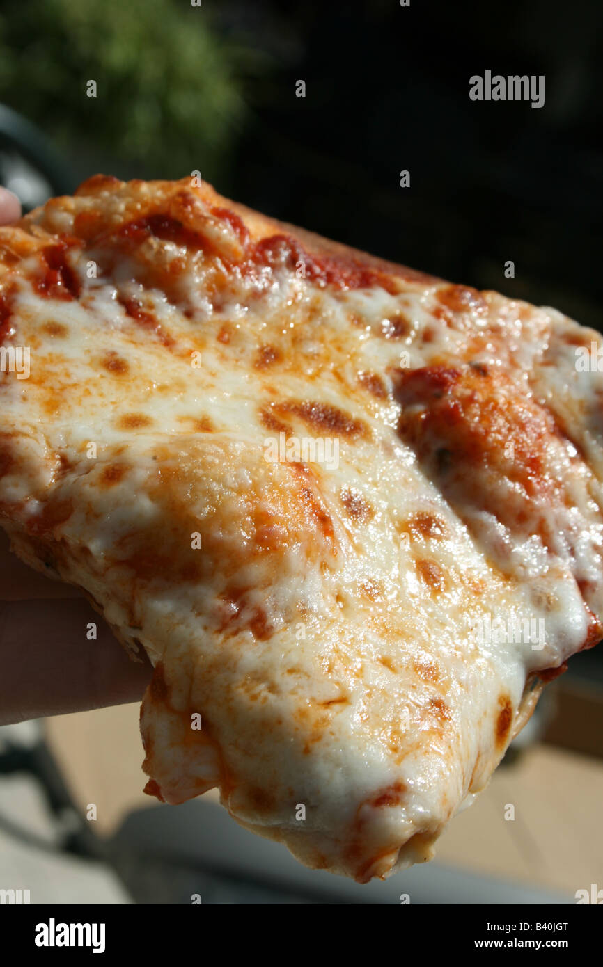 large slice of fresh cheese pizza closeup Stock Photo - Alamy