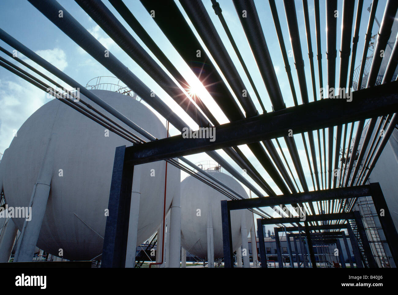 Pipes and storage tanks in an industrial refinery plant Stock Photo - Alamy