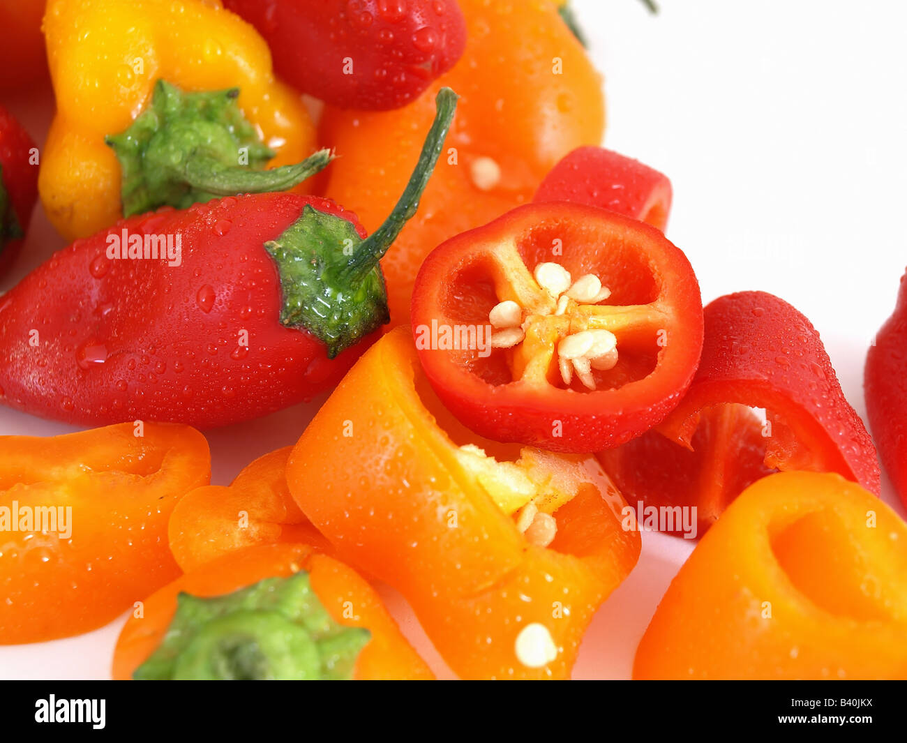 Colorful cut red yellow and orange bell peppers with sprinkles of water ...