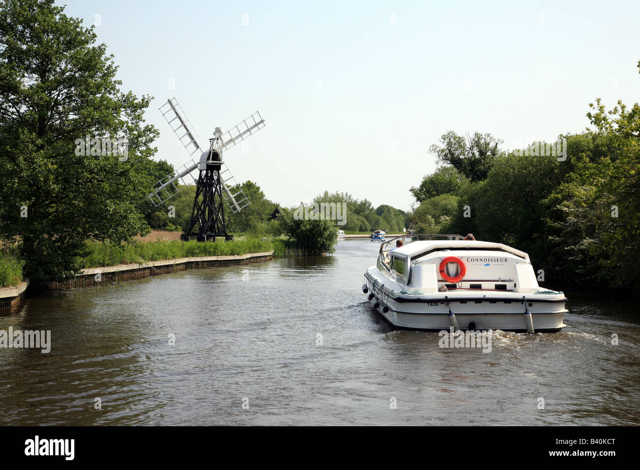 River Boat passing windmill on Norfolk Broads Stock Photo - Alamy