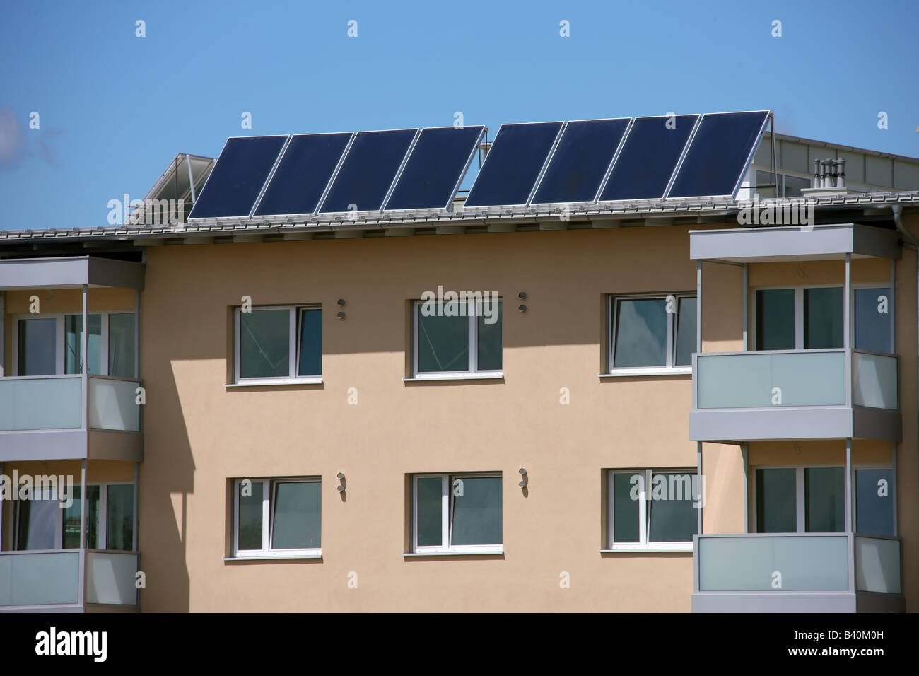 Multi-party house with solar collectors Stock Photo - Alamy