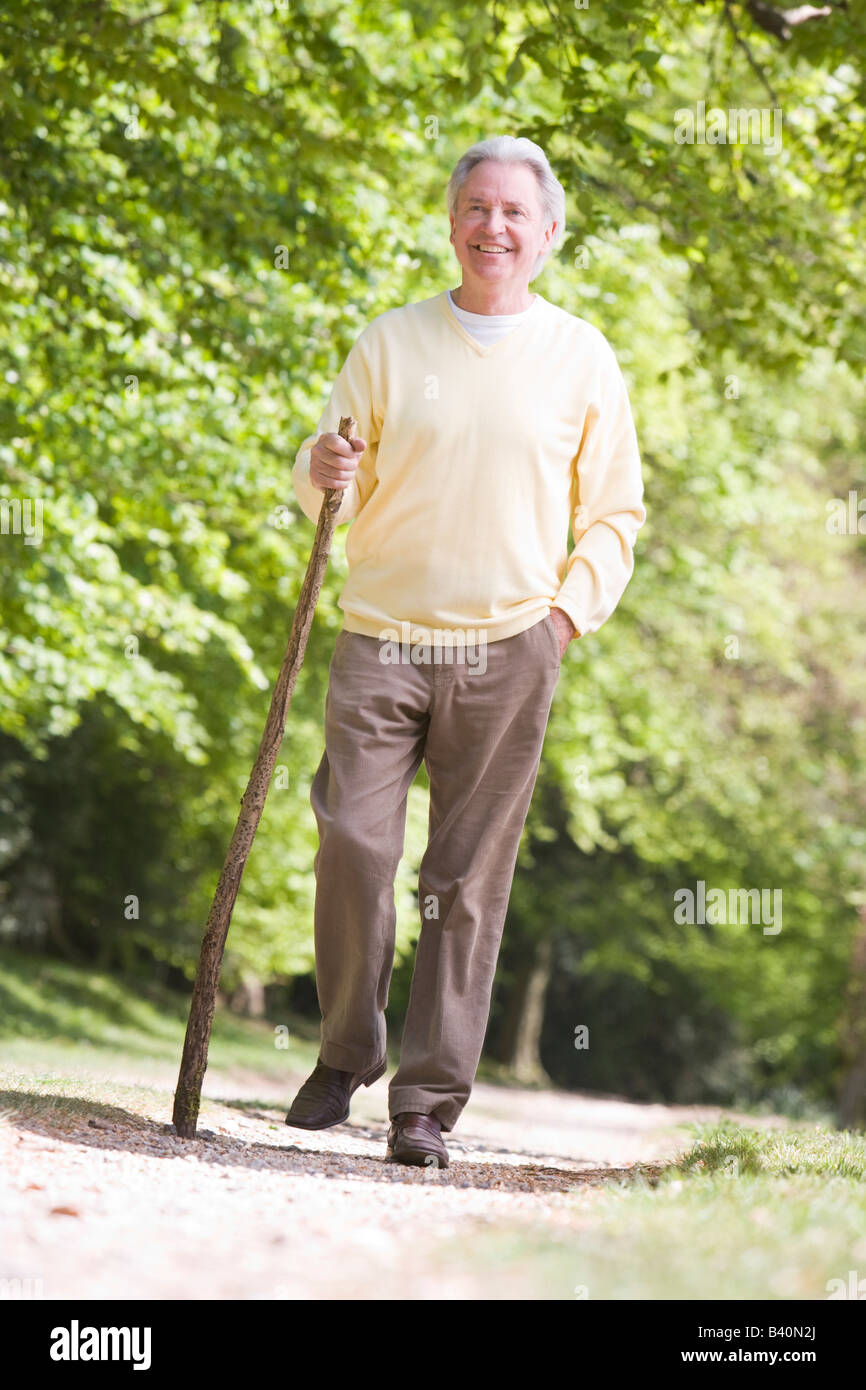 Man walking outdoors smiling Stock Photo - Alamy