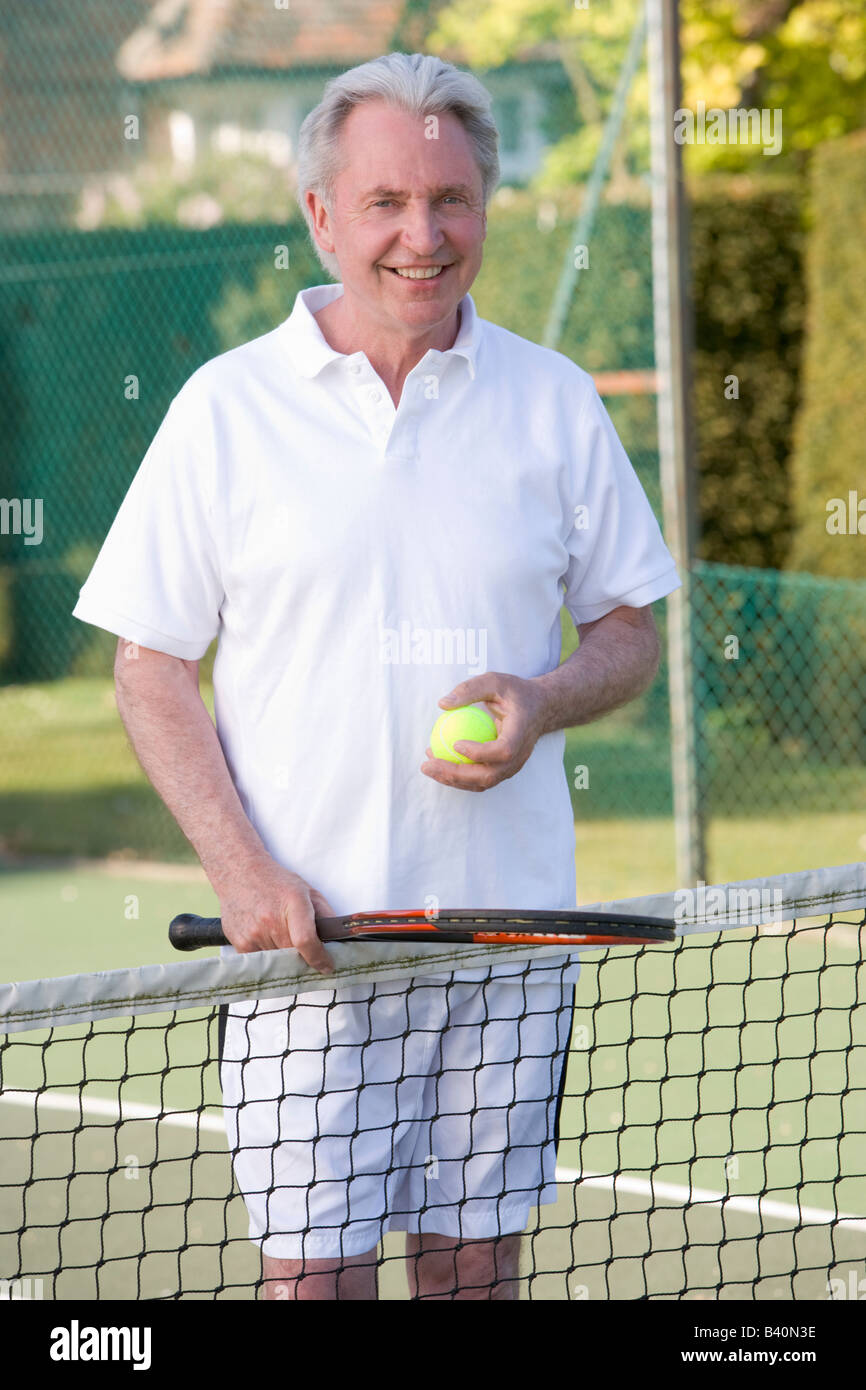 Man playing tennis and smiling Stock Photo - Alamy