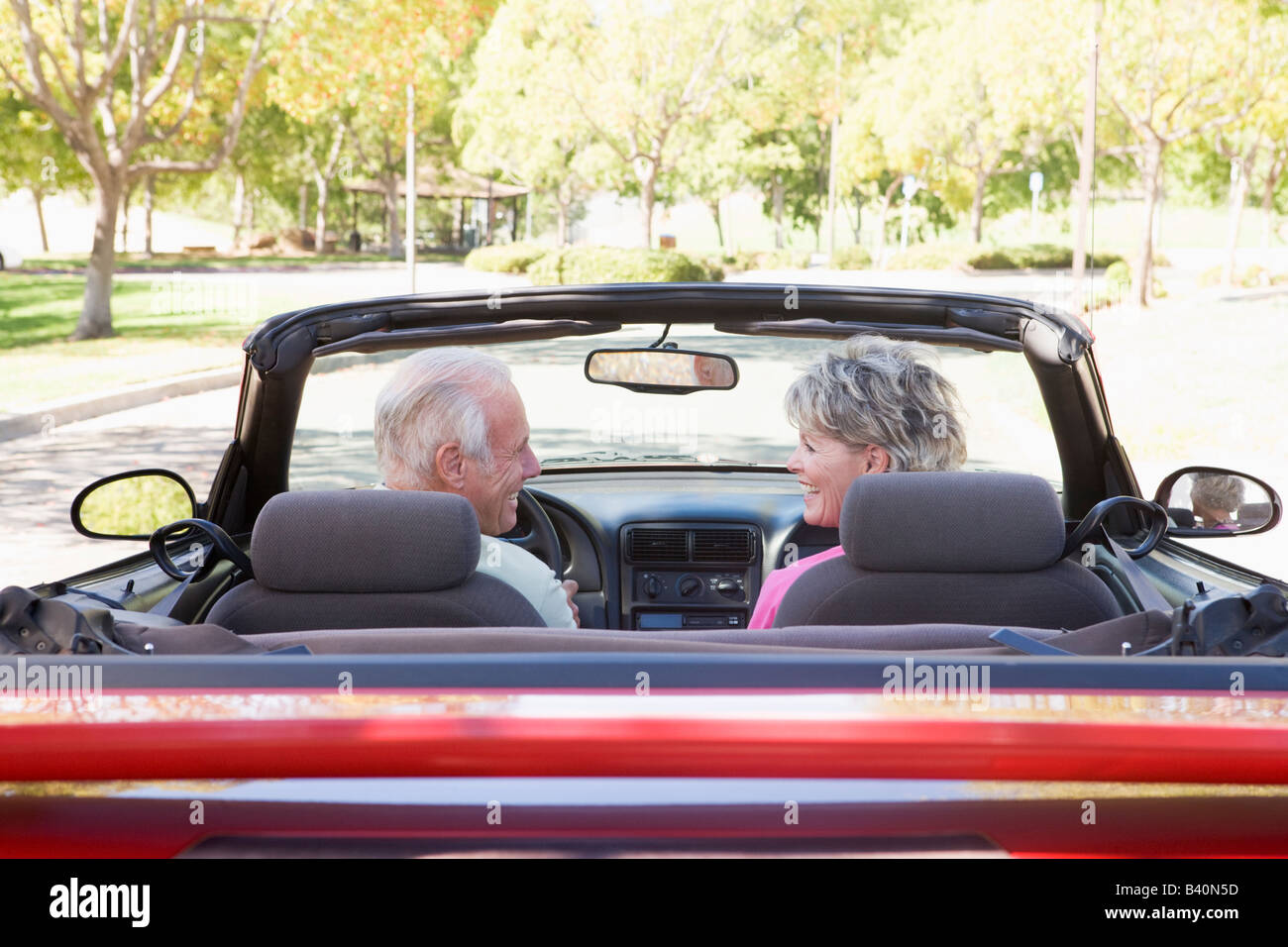 Couple in convertible car smiling Stock Photo - Alamy