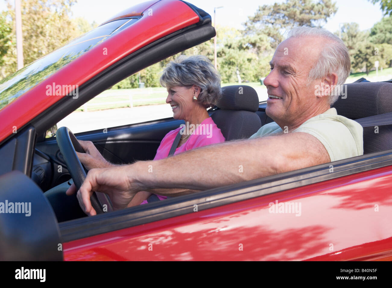 Couple in convertible car smiling Stock Photo - Alamy