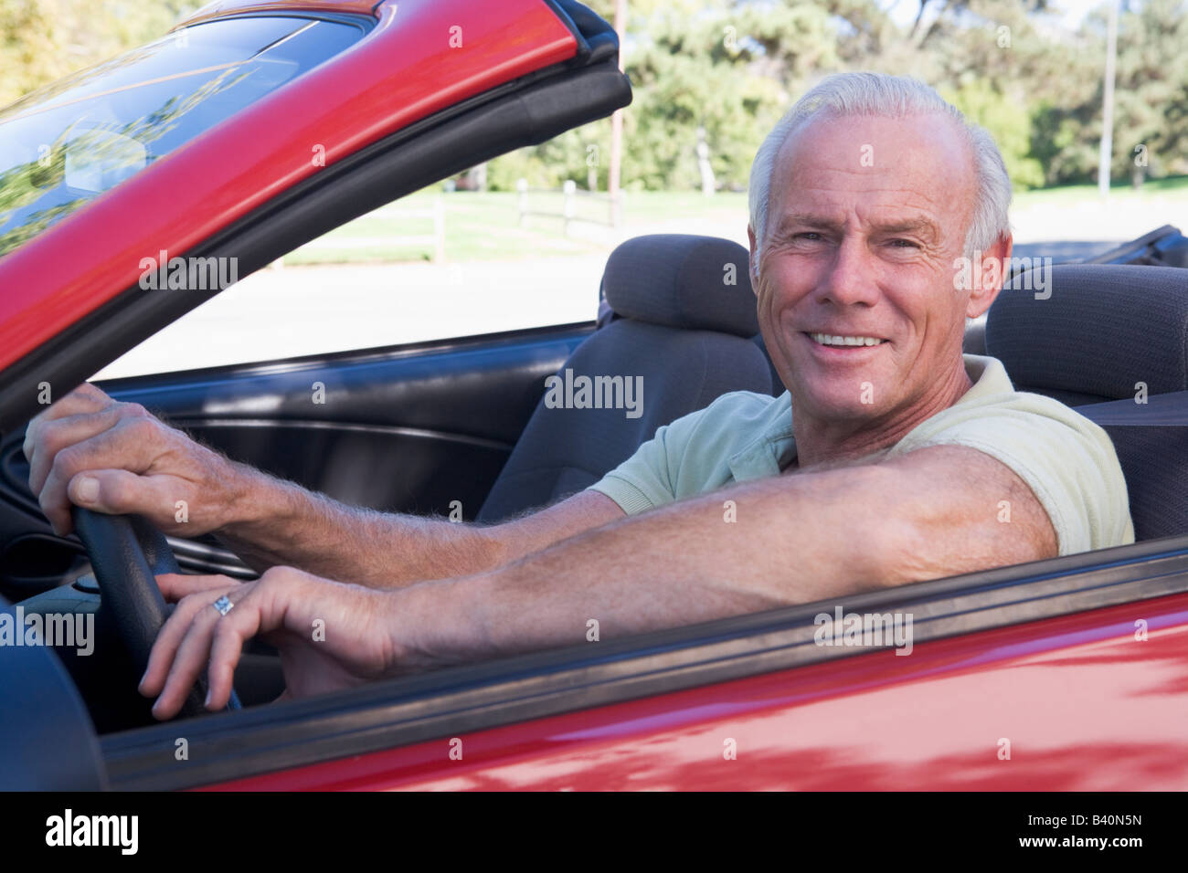 Man in convertible car smiling Stock Photo - Alamy