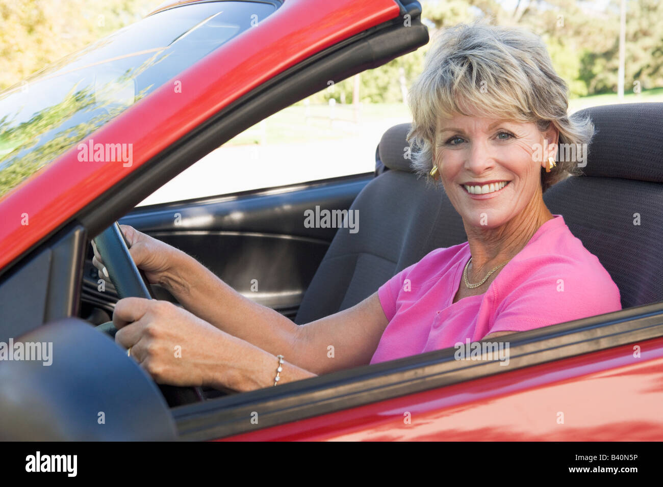 Woman in convertible car smiling Stock Photo - Alamy
