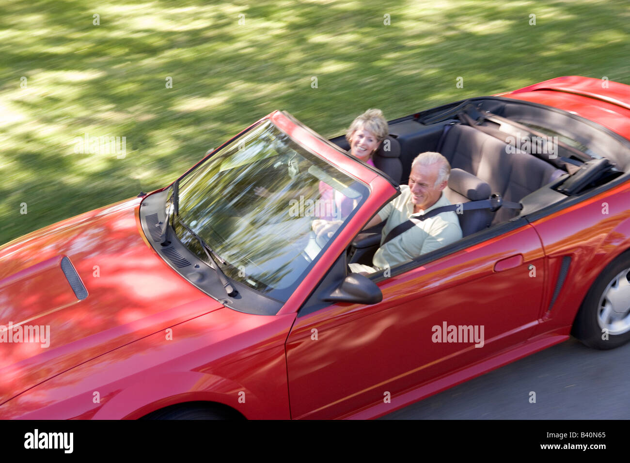 Couple in convertible car smiling Stock Photo - Alamy