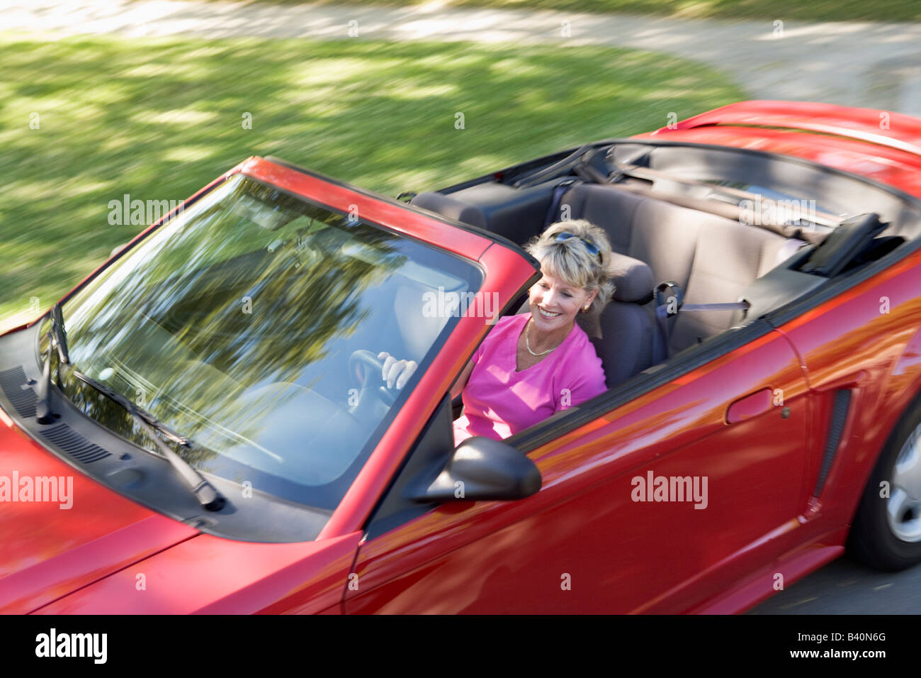 Woman in convertible car smiling Stock Photo - Alamy