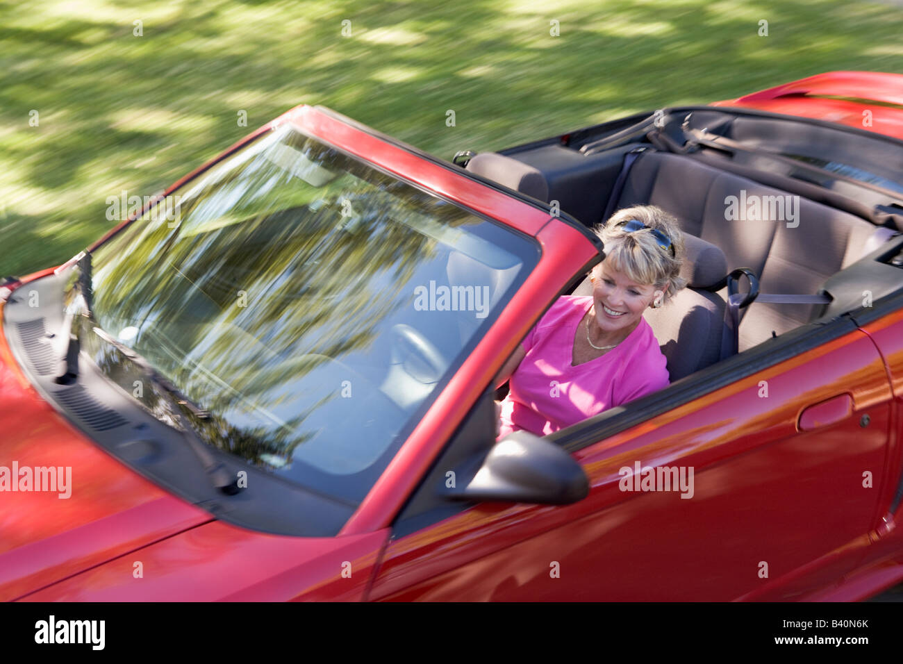 Woman in convertible car smiling Stock Photo - Alamy
