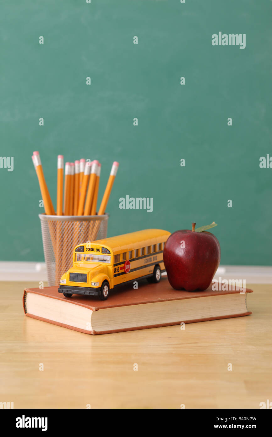School education still life with pencils apple book and toy school bus ...
