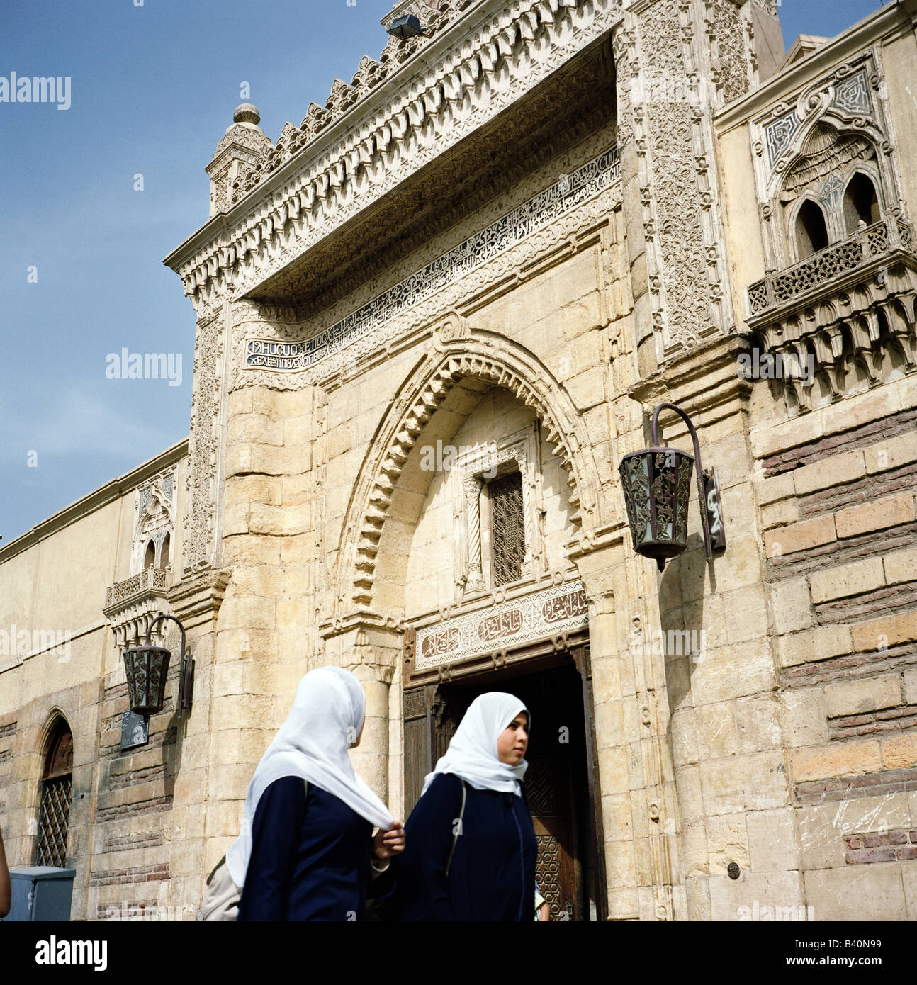 Muslim schoolgirls walk past a Coptic Church in Cairo, Egypt Stock ...