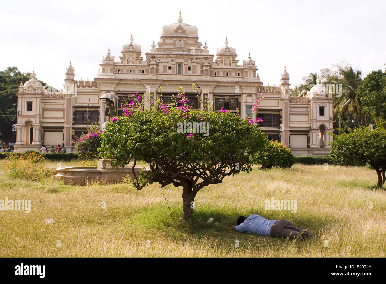 A man sleeps in the grounds of the Jagan Mohan Palace in Mysore, India ...