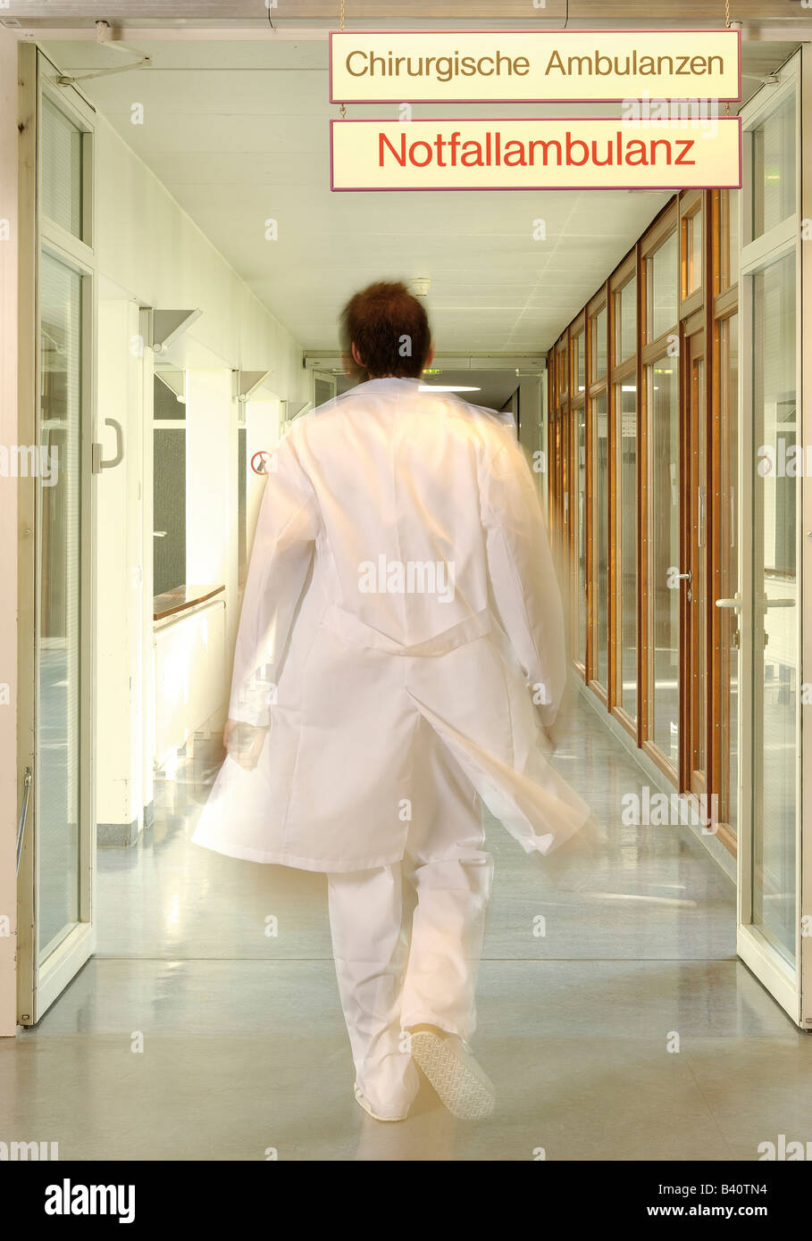 Doctor walking along hospital floor Stock Photo - Alamy