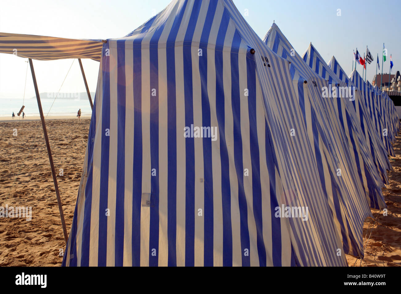 Blue and white striped sun tents on beach, Grand Plage, St Cast le ...