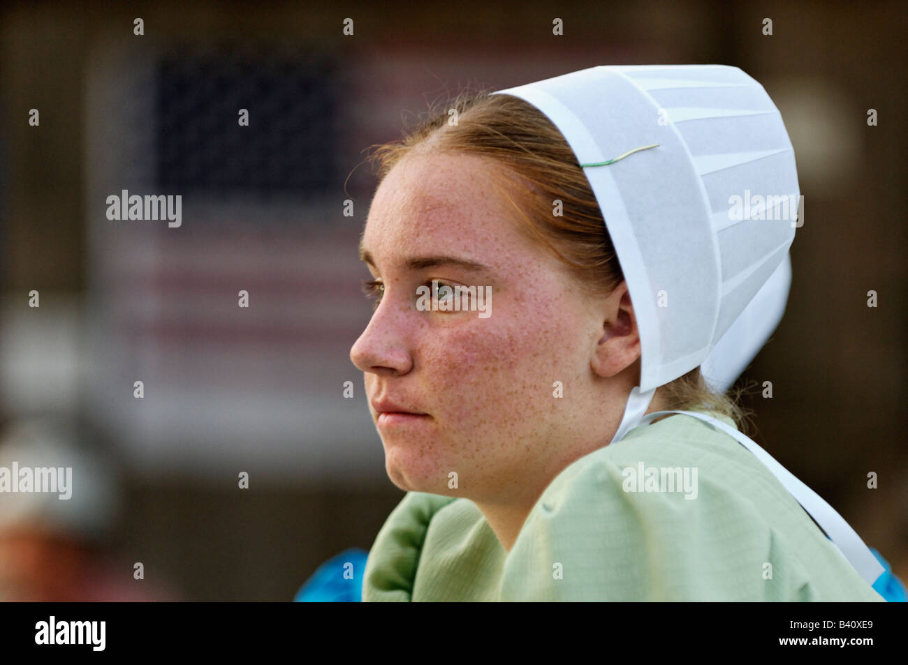 Mennonite Teenage Girl at Heritage Festival with American Flag Behind ...
