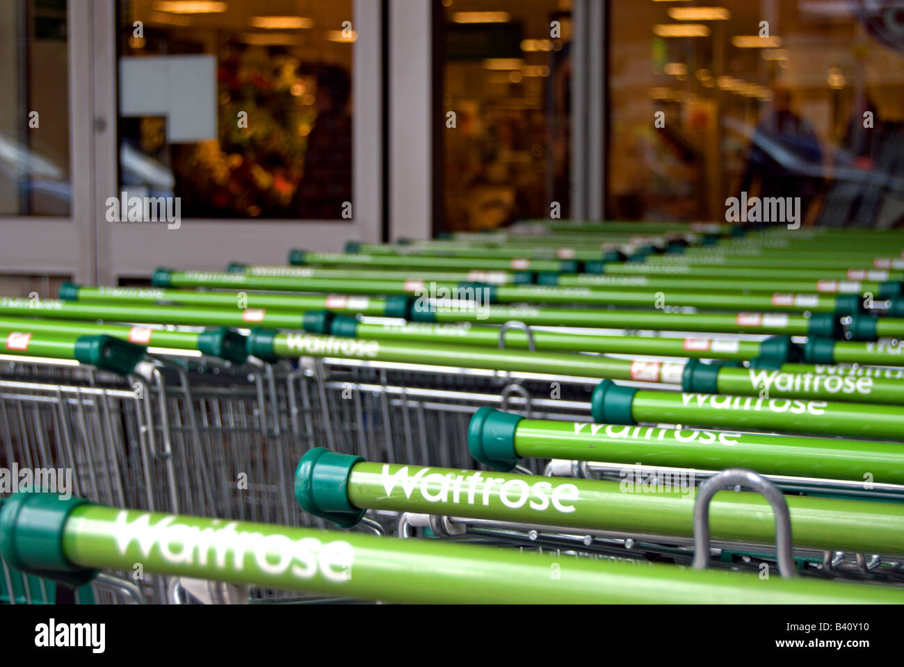 columns of shopping trolleys outside a branch of waitrose supermarket ...