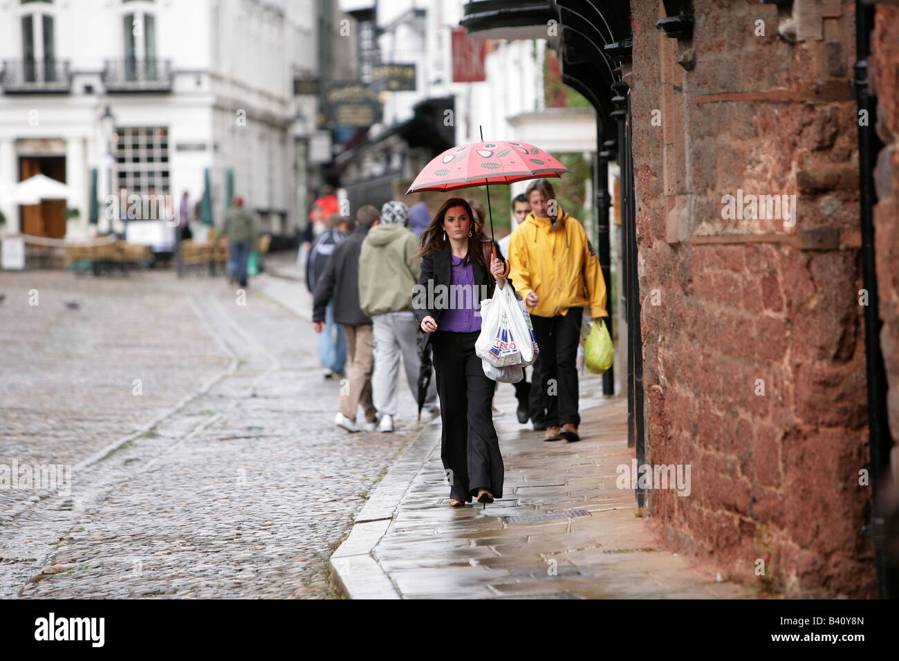 People in Exeter in the rain Stock Photo - Alamy