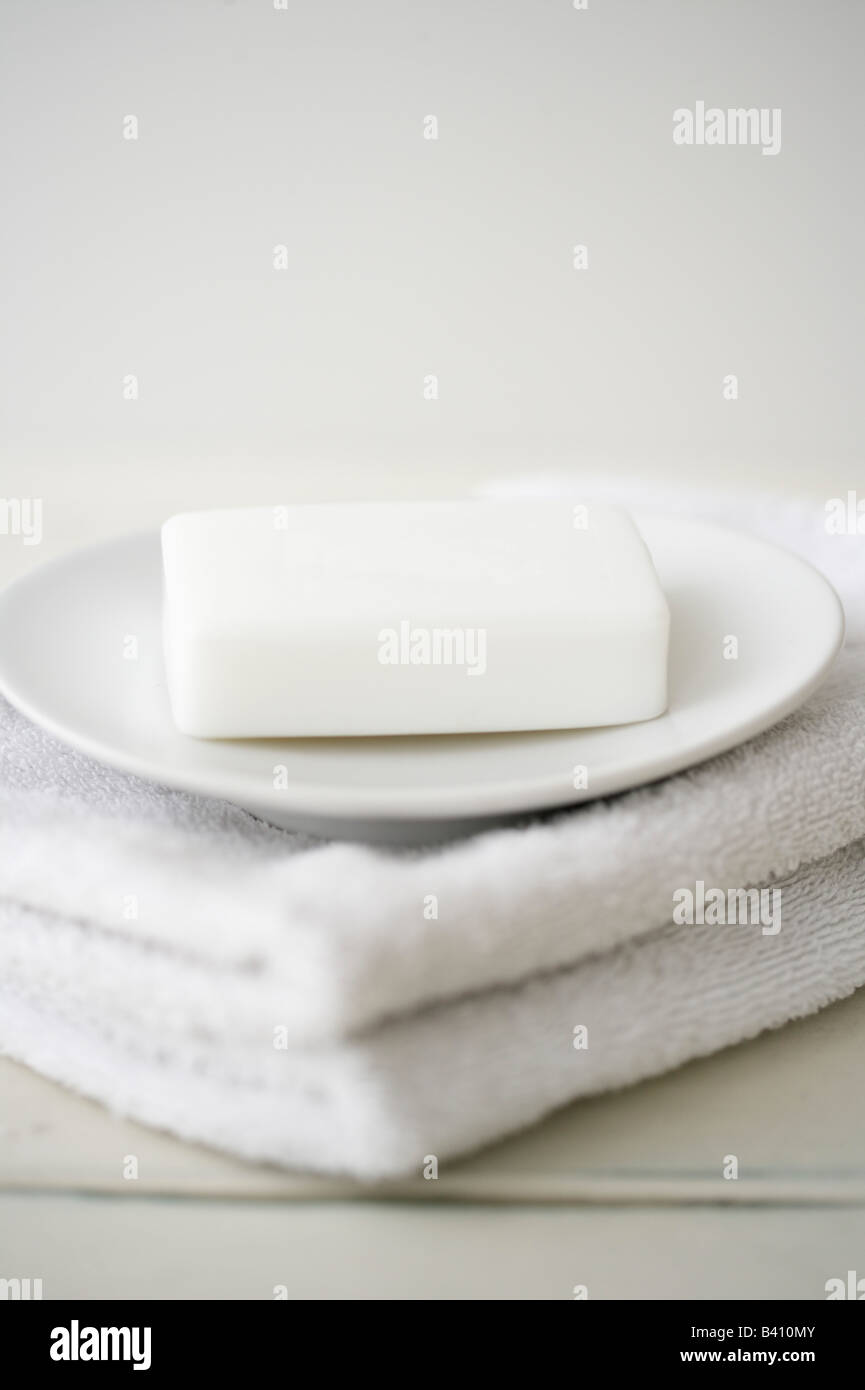 Cake of soap on a disc on a stack of towels Stock Photo - Alamy
