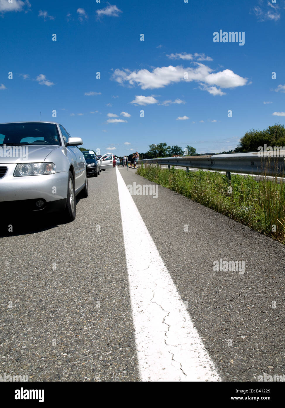 Congestion of cars on the highway with people waiting on the road Stock ...