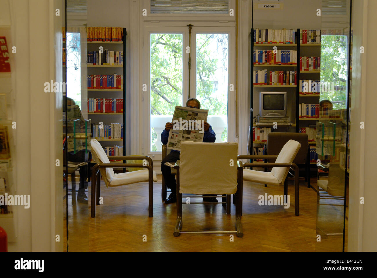 Man reading newspaper in a public library in Egypt Stock Photo - Alamy