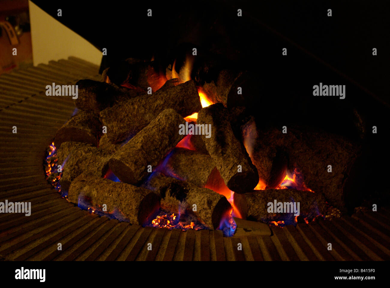 Gas log fire in dark room small red flames creating a Christmas ...