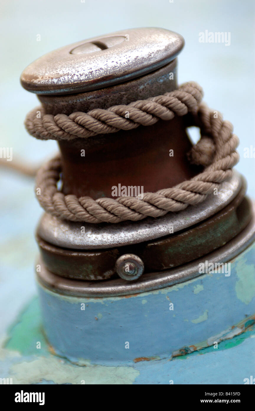 USA, Seattle, WA, Small, weathered capstan with a rope tied around it ...