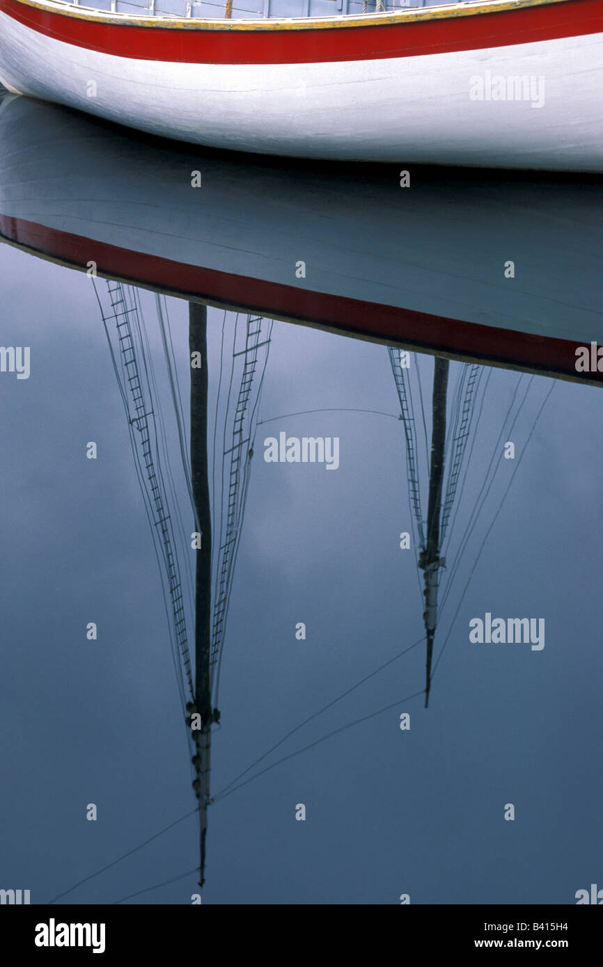 USA, Seattle, WA, Mast reflection in calm water with hull of white ...