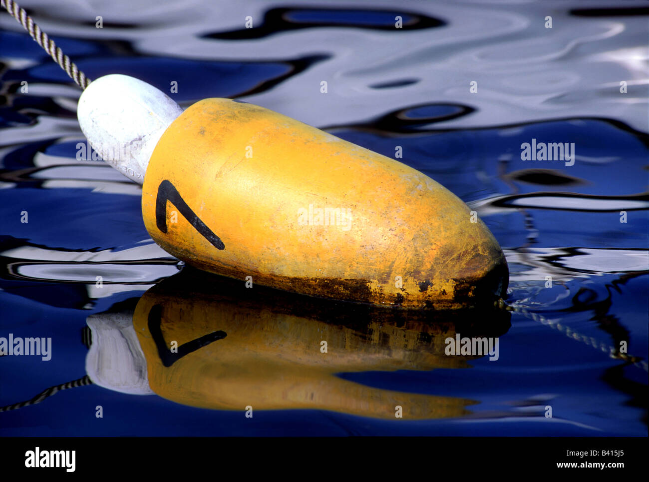 USA, Seattle, WA, Yellow buoy floating on a blue water surface Stock ...