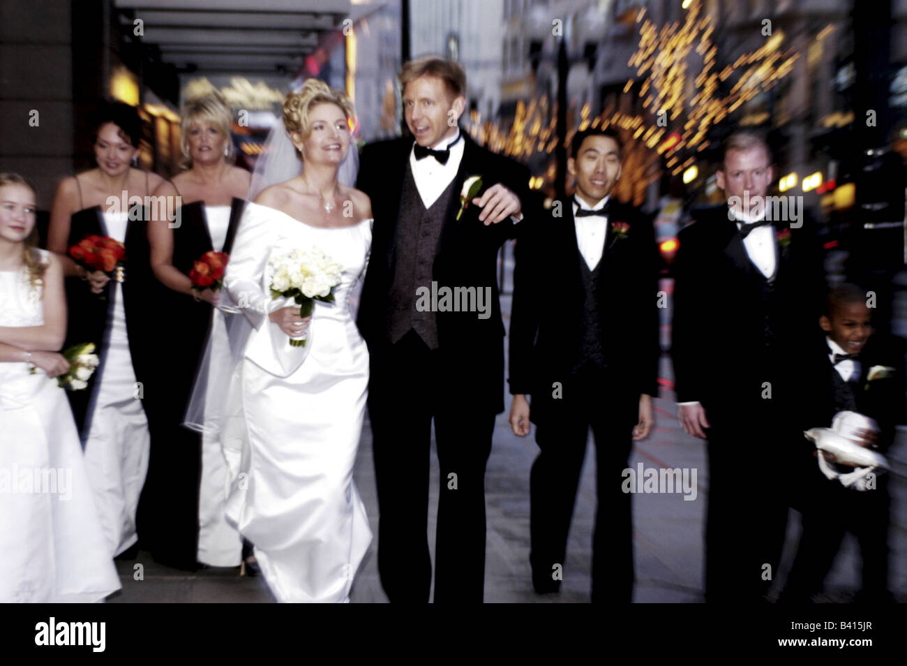 USA, Washington, Seattle, Wedding party walking through illuminated ...